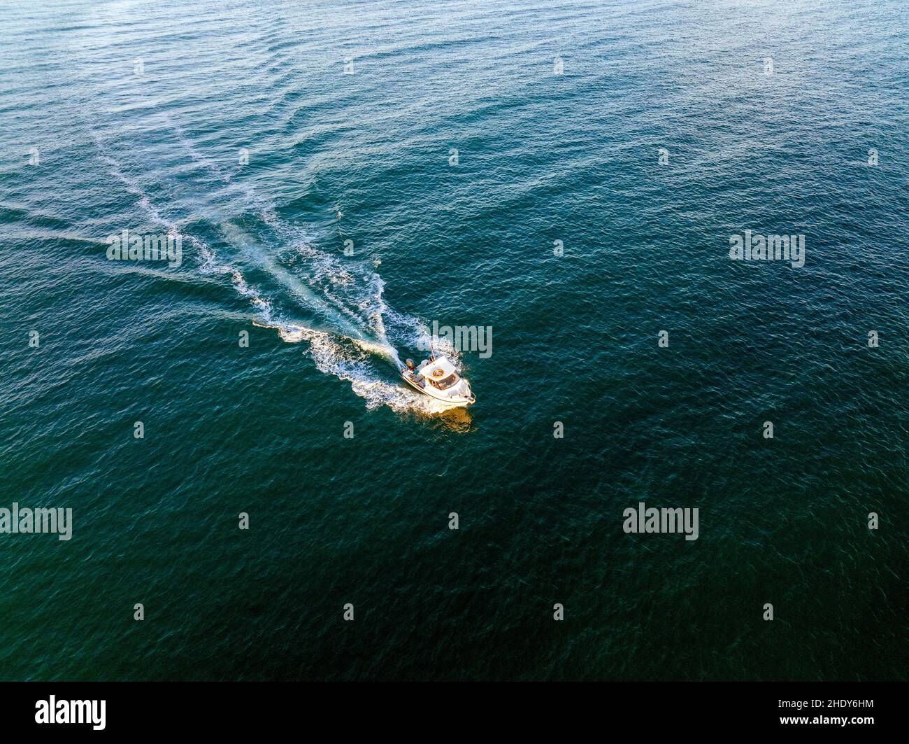 High angle drone view of fast boat floating on rippling sea and ...