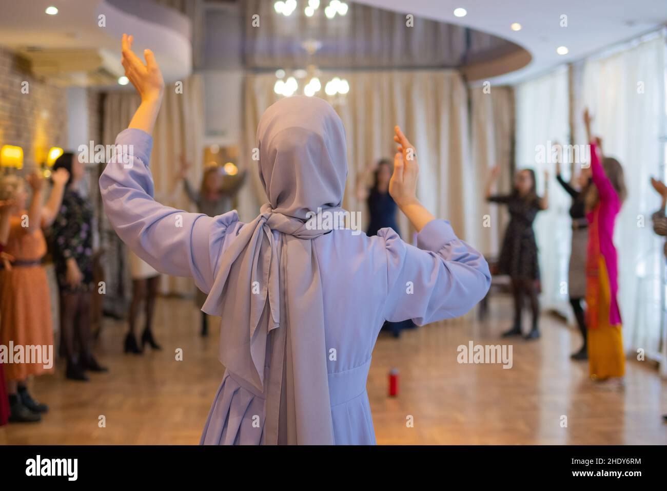 Woman putting hands up and dancing. Excited young female celebrating a ...