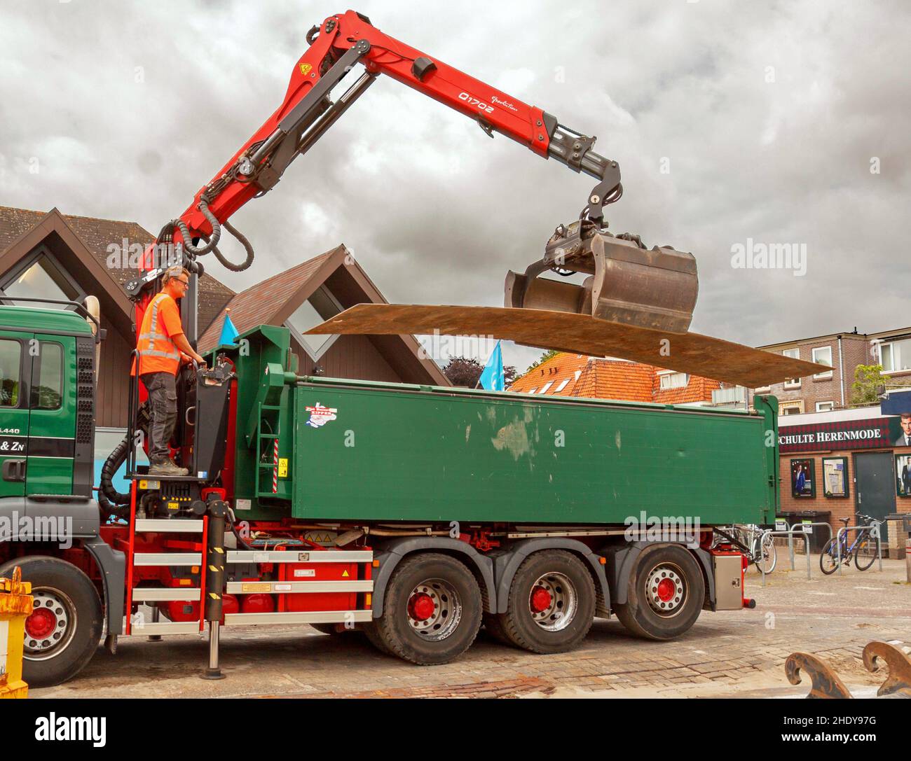 Unloading steel plates for road reconstruction works Stock Photo - Alamy