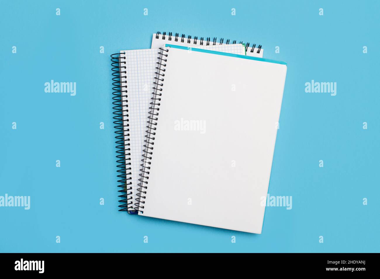 Blank notebooks on a light blue background Stock Photo - Alamy
