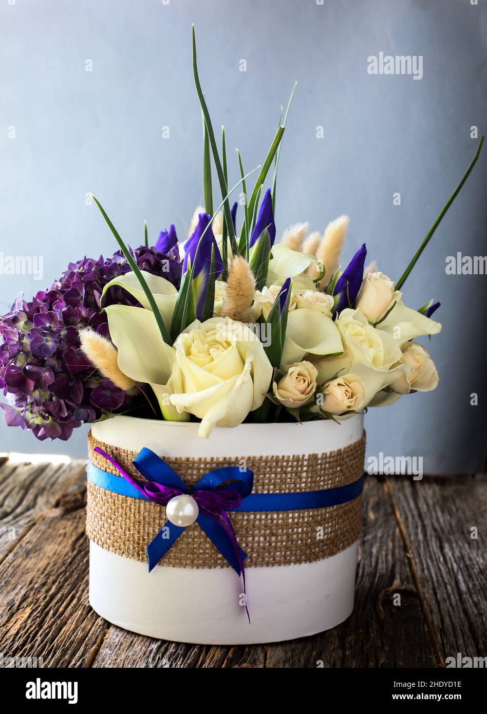 Beautiful flower composition on rustic wooden table near window Stock ...