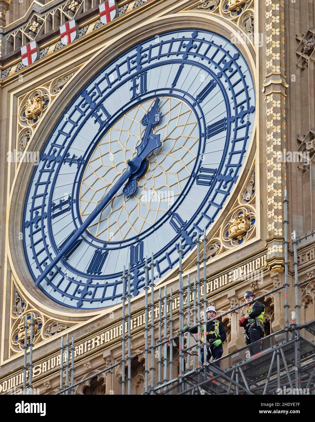 Construction Workers remove scaffolding from the clock face of ...