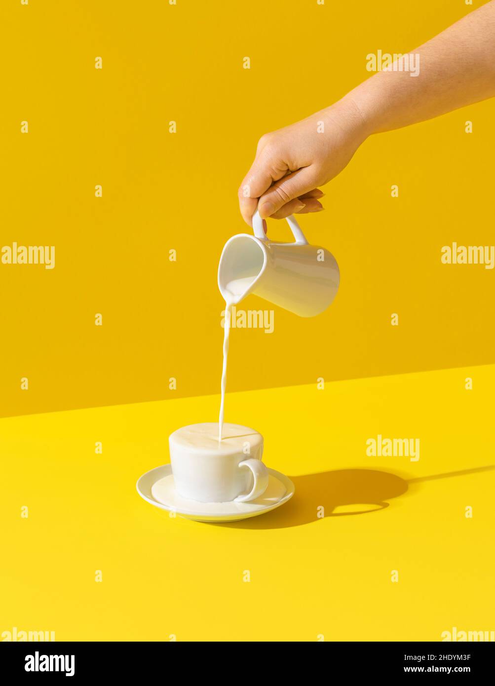 Milk pouring yellow ceramic hi-res stock photography and images - Alamy