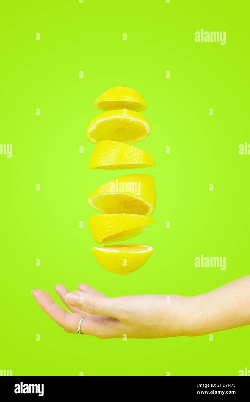 Fresh organic yellow lemon fruit slice levitation falling suspended in ...