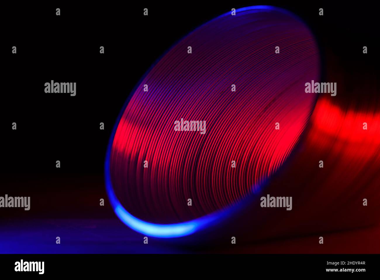 Closeup of coiled metal spring with sufficiently high strength in red ...