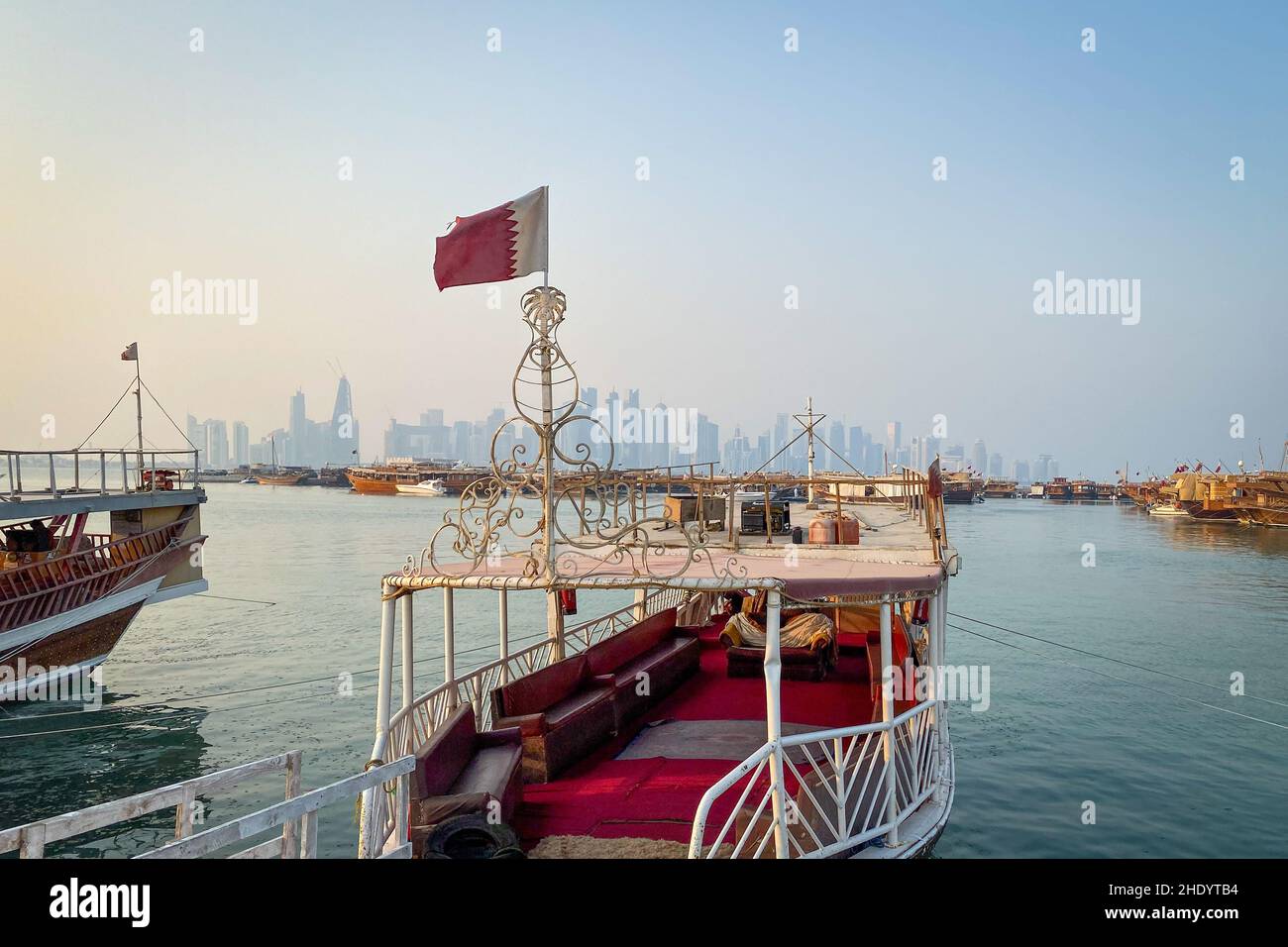 Cityscape and downtown skyscapers seen through traditional dhow boats ...