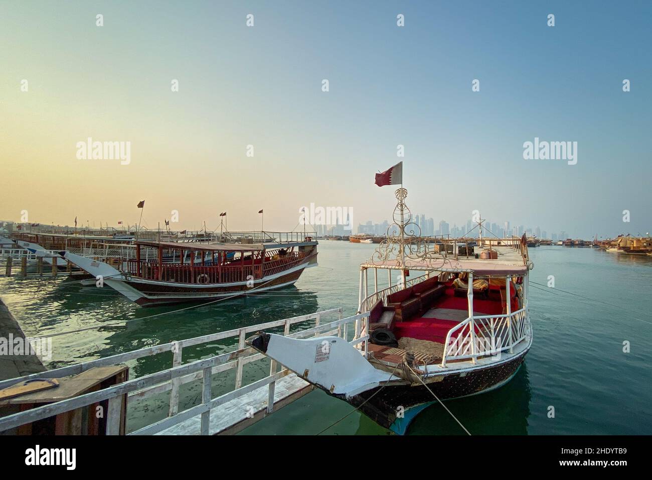 Cityscape and downtown skyscapers seen through traditional dhow boats ...