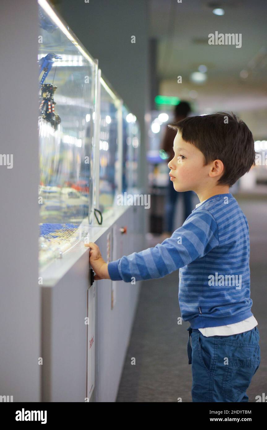 Boy looking at Lego bricks Stock Photo - Alamy