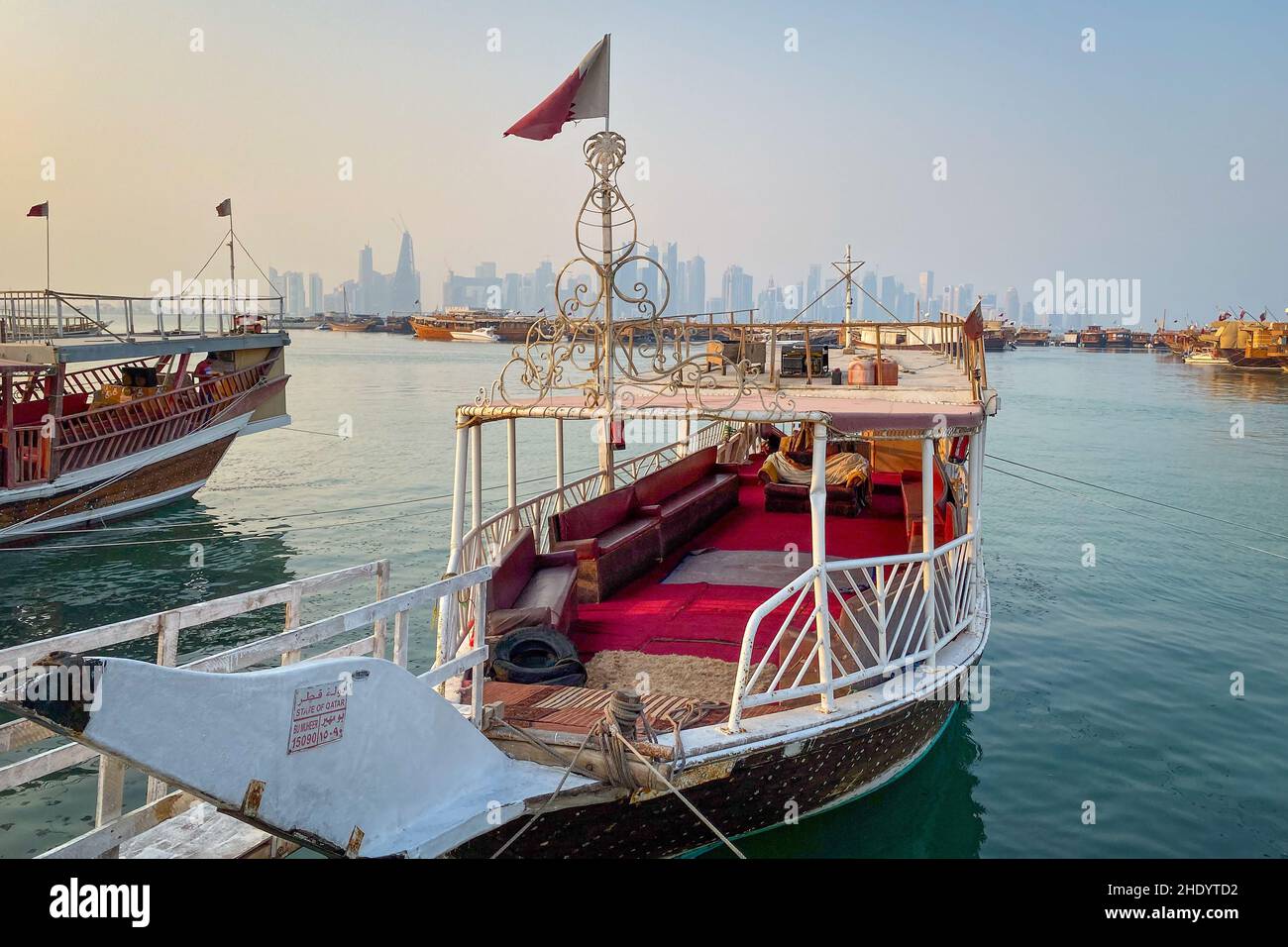 Cityscape and downtown skyscapers seen through traditional dhow boats ...
