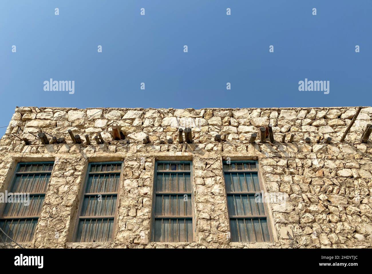 Facade of house with traditional style in Qatar against blue sky Stock ...