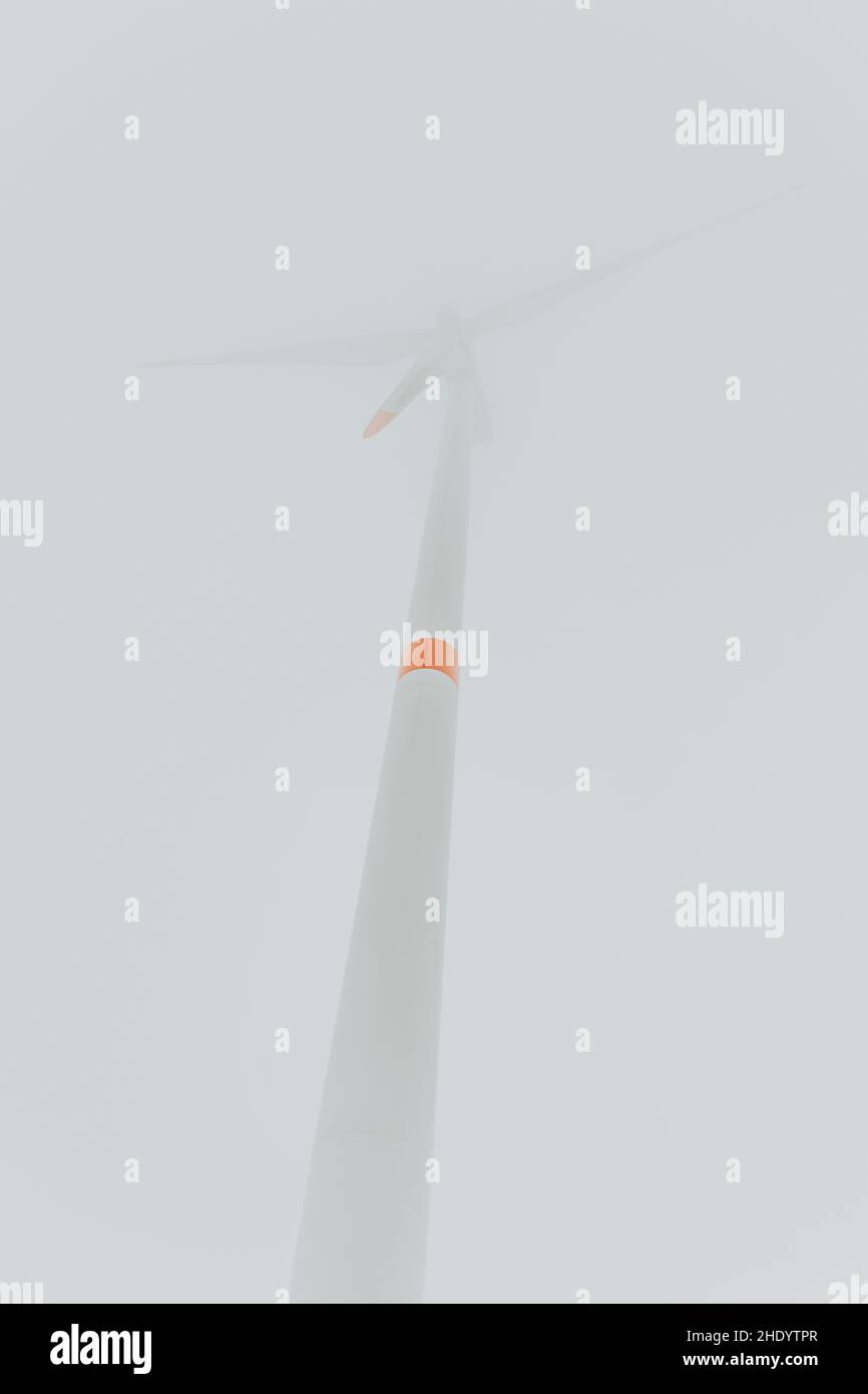 Windturbine in fog from low angle Stock Photo - Alamy