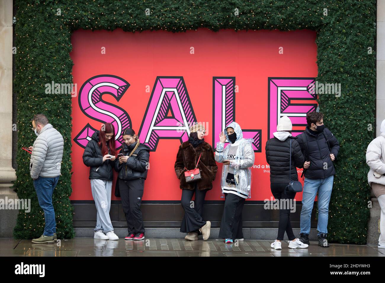 People queue in front of a Sale logo outside Selfridges department ...