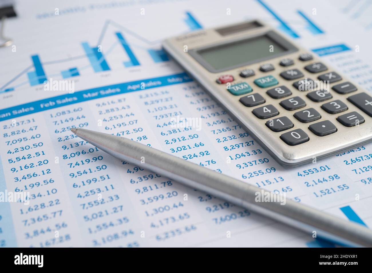Calculator on preadsheet table paper with graph. Finance development ...