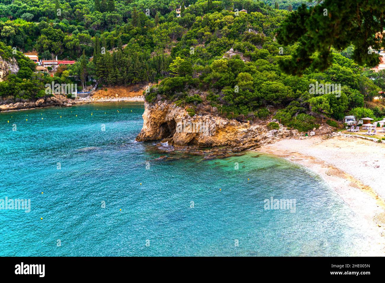 Green hills with rocky steep slopes and mountains surround hotel resort ...