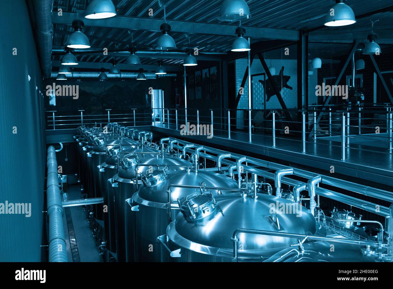 Industrial interior of modern craft brewery with chrome cylindrical ...