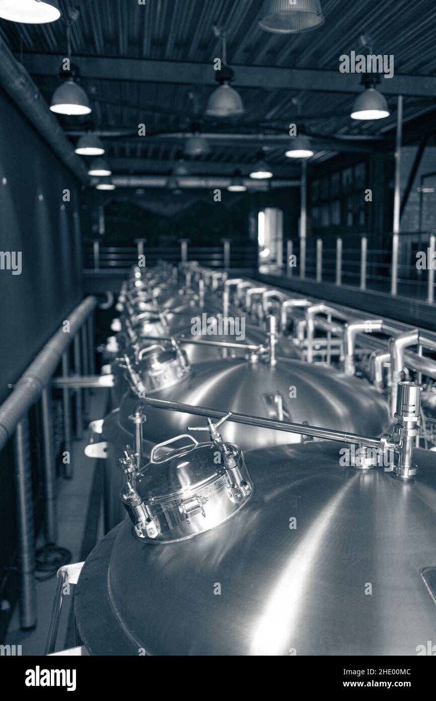 Private microbrewery. Modern beer plant with brewering kettles, tubes ...