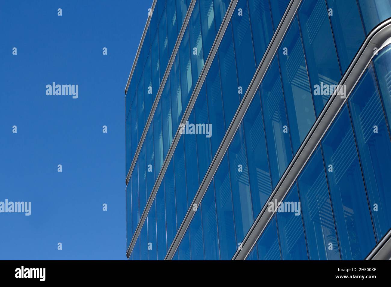 geometric blue glass facade on sky. Polygonal detail of glass facade ...