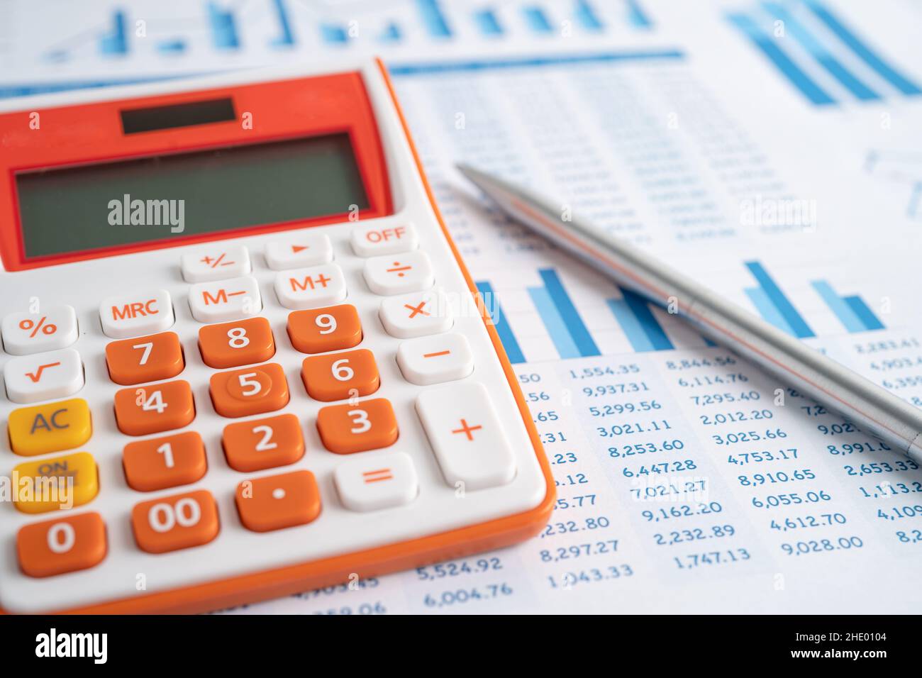 Calculator on chart and graph spreadsheet paper. Finance development ...