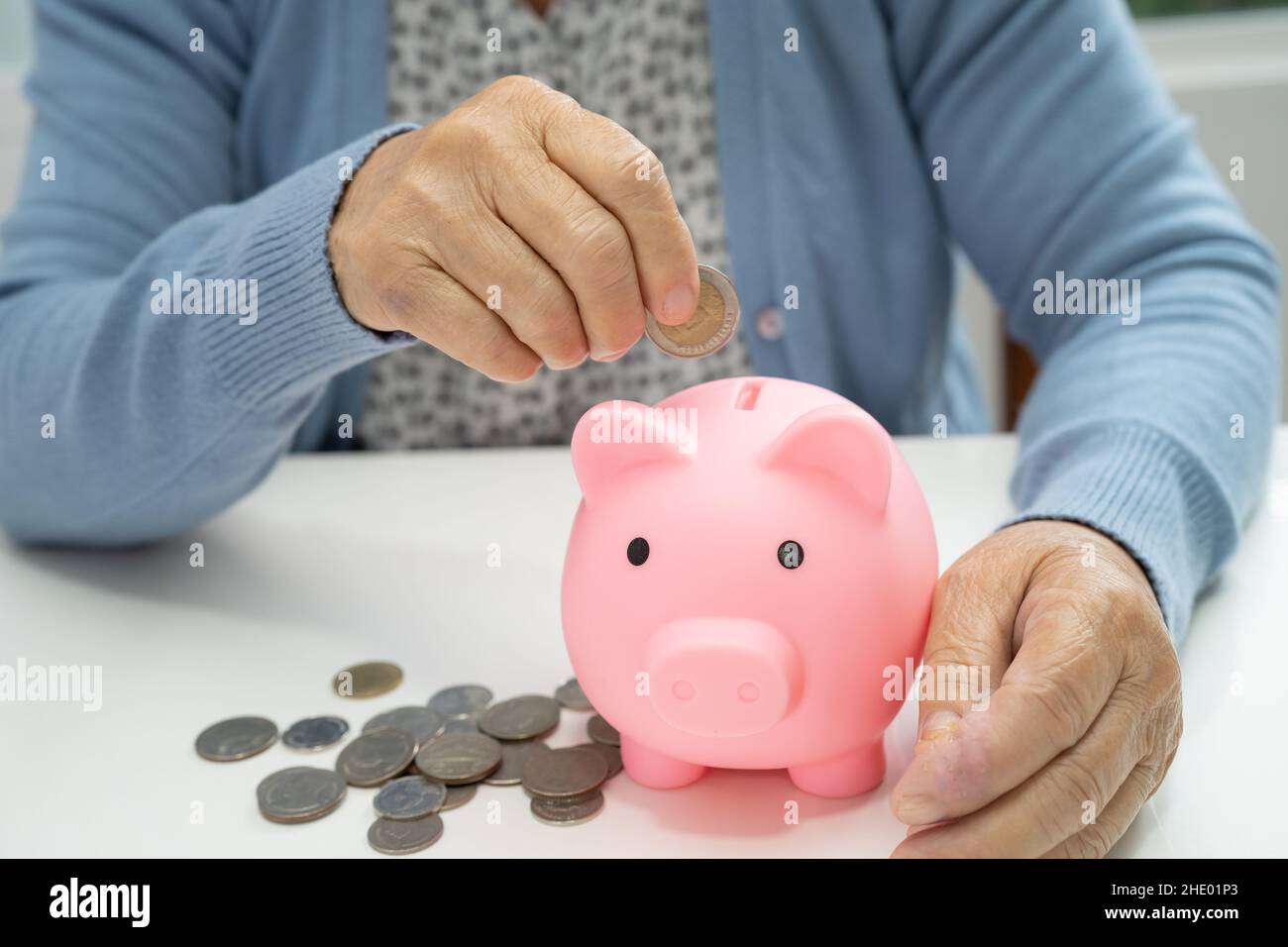 Asian senior or elderly old lady woman holding counting coin money in ...