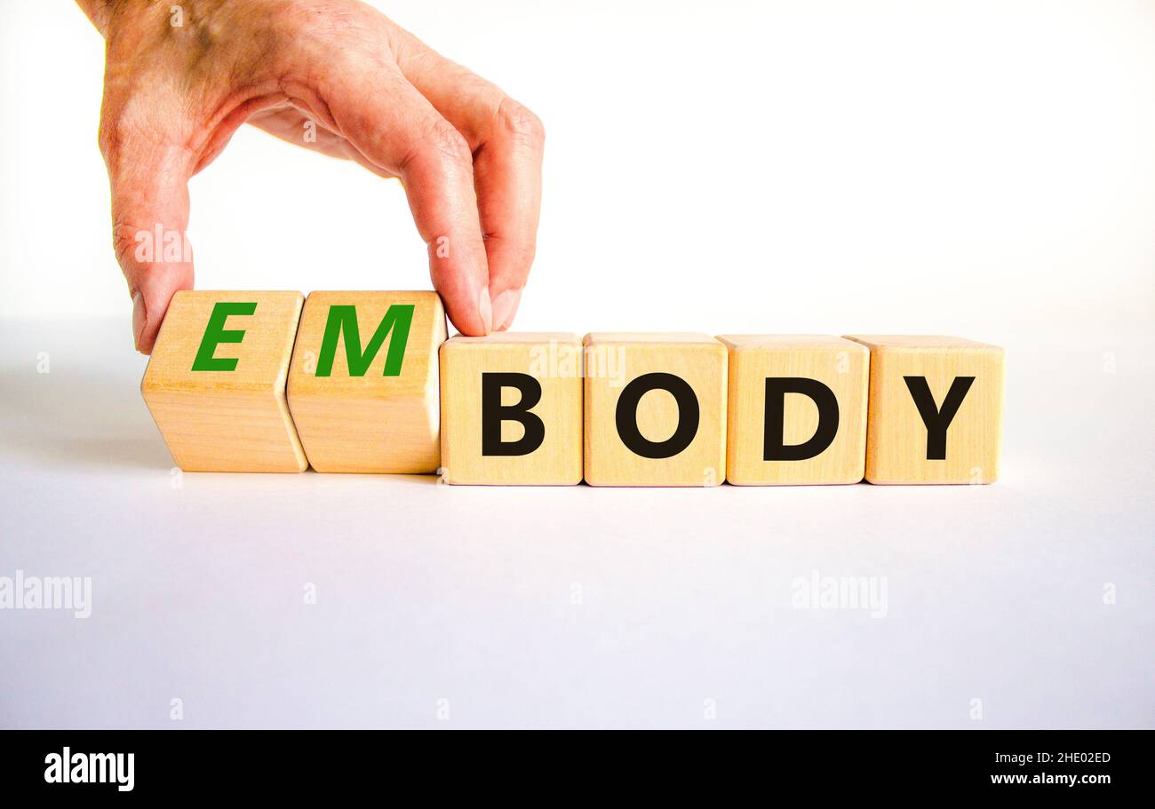 Body and embody symbol. Doctor turns wooden cubes and changes the ...