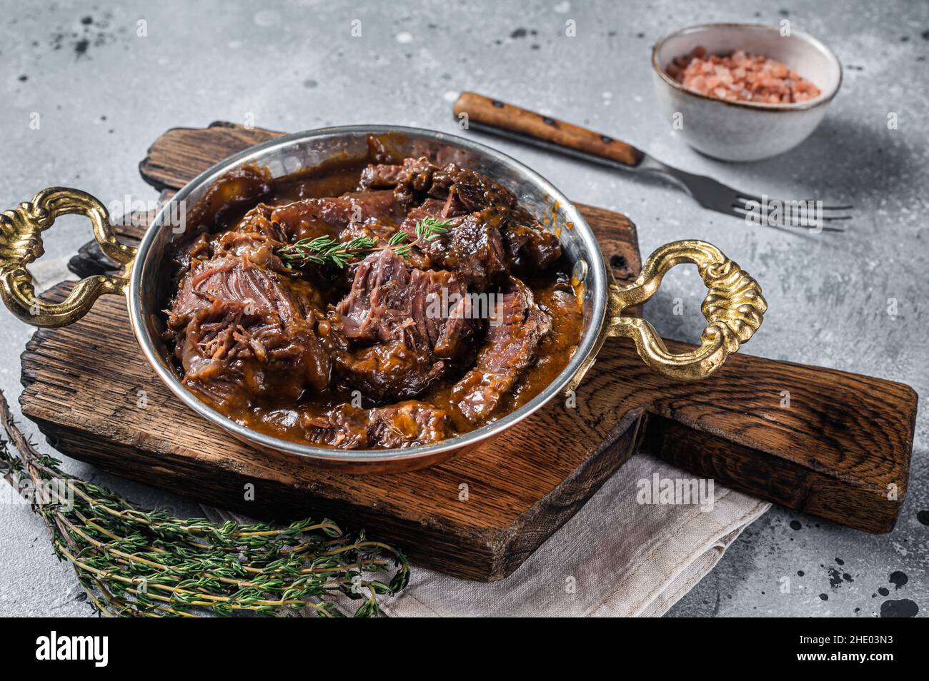 German braised beef cheeks in brown red wine sauce. Gray background ...