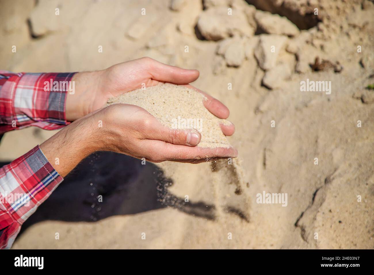 Sand quarry in the hands of a man. Selective focus Stock Photo - Alamy
