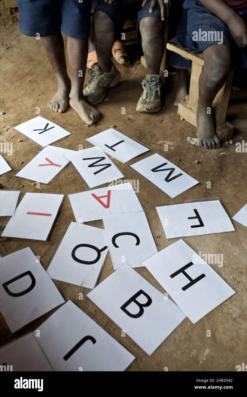 Vertical closeup of the school children in Uganda learning the letters ...