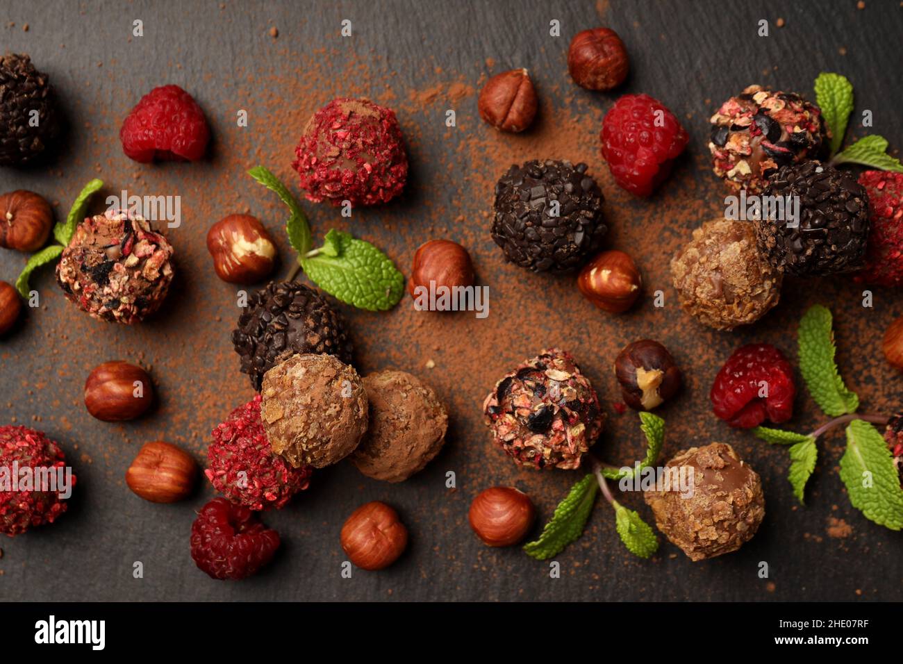 Concept of sweets with chocolate candies on dark textured background ...