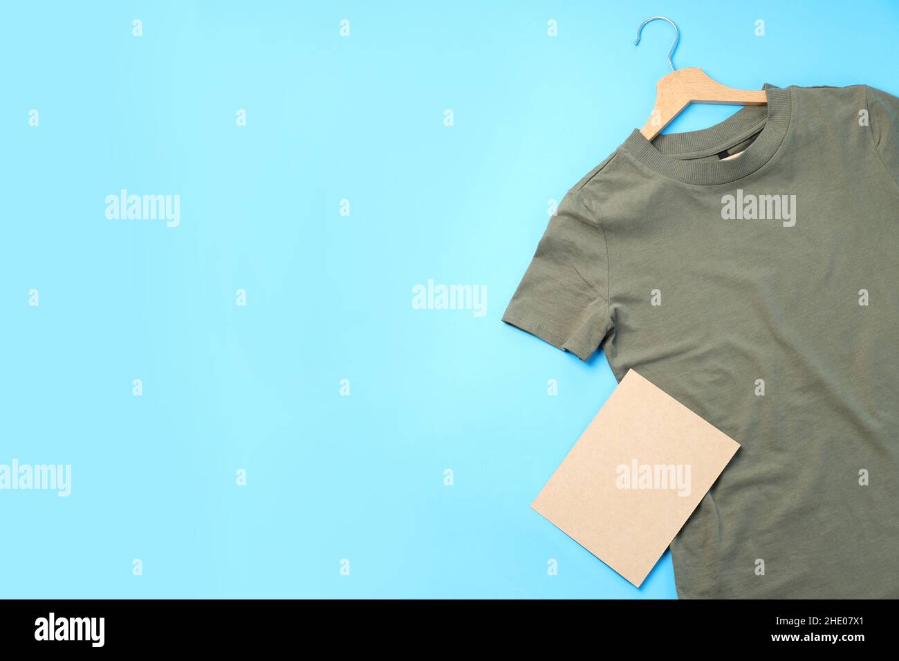 Blank t-shirt and carton sheet on blue background Stock Photo - Alamy