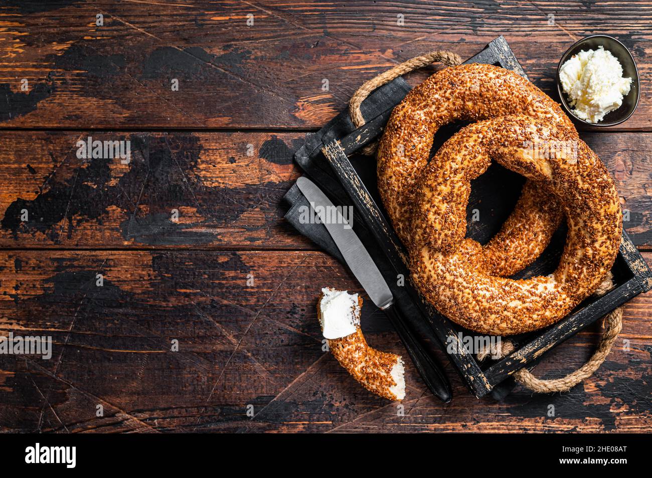 Stack of fresh baked Turkish simit bagel with kaymak. Wooden background ...