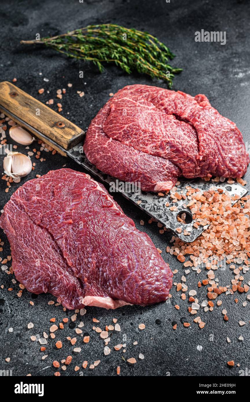 Raw Beef cheeks, fresh veal meat on butcher cleaver. Black background ...