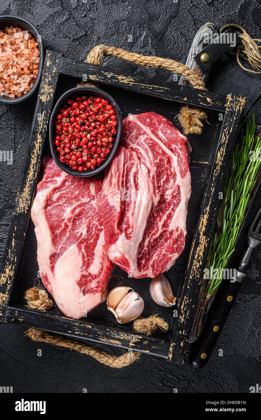Fresh Raw Chuck roll, Tenders beef steaks in a wooden tray with herbs ...