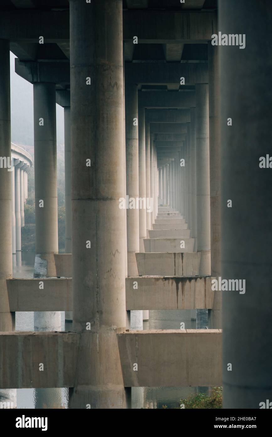 Vertical shot of a bridge with concrete columns Stock Photo - Alamy