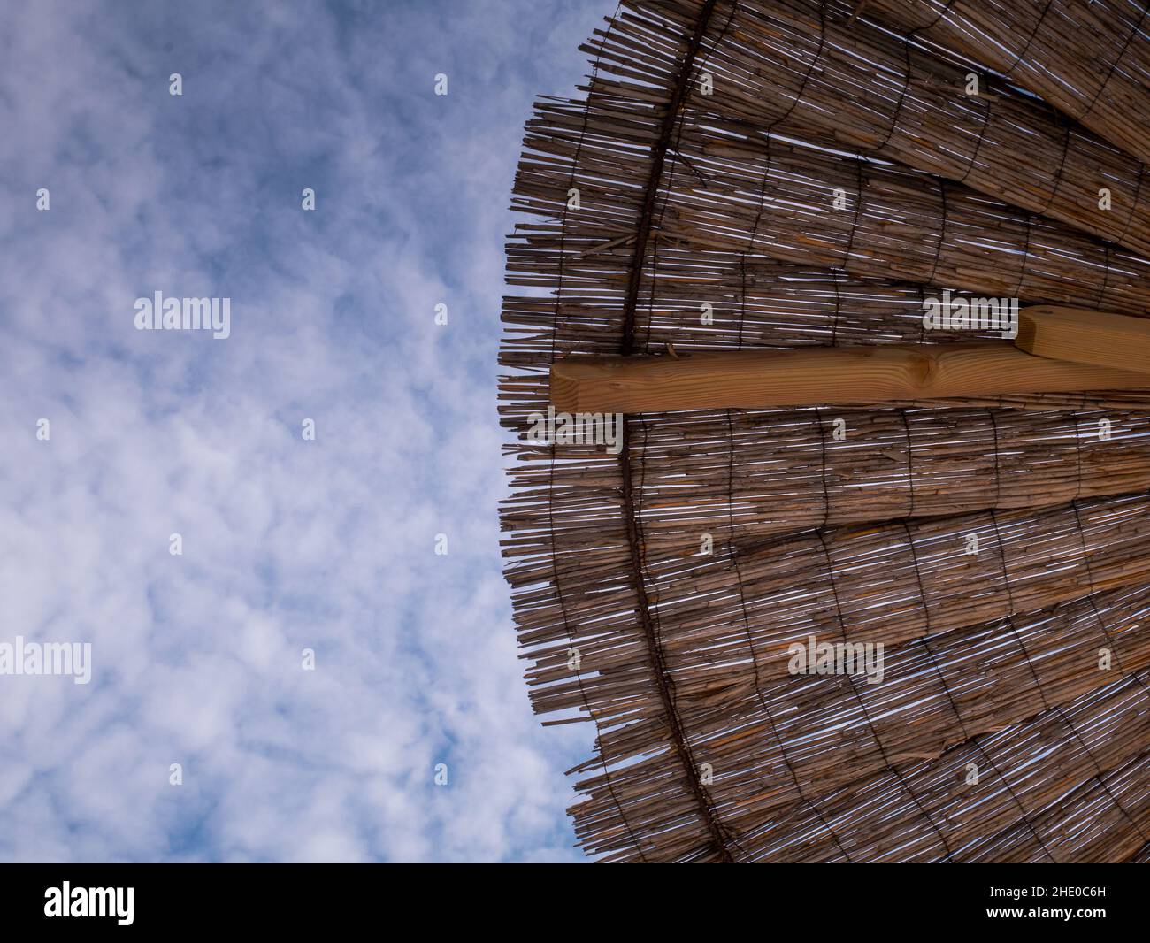Part of the straw beach umbrellas and View of the beautiful blue sky ...