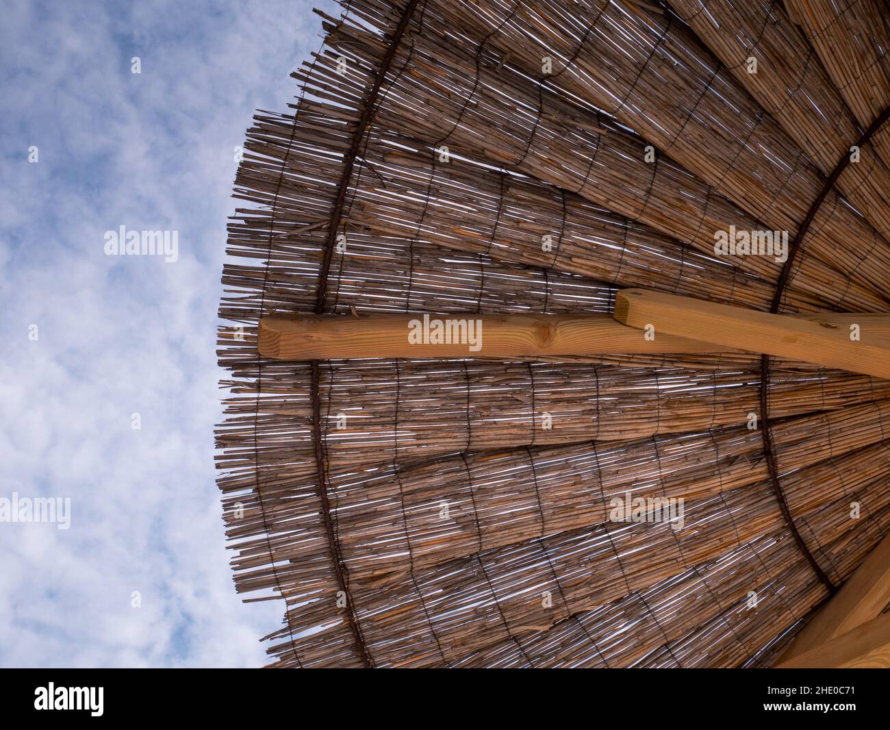 Part of the straw beach umbrellas and View of the beautiful blue sky ...