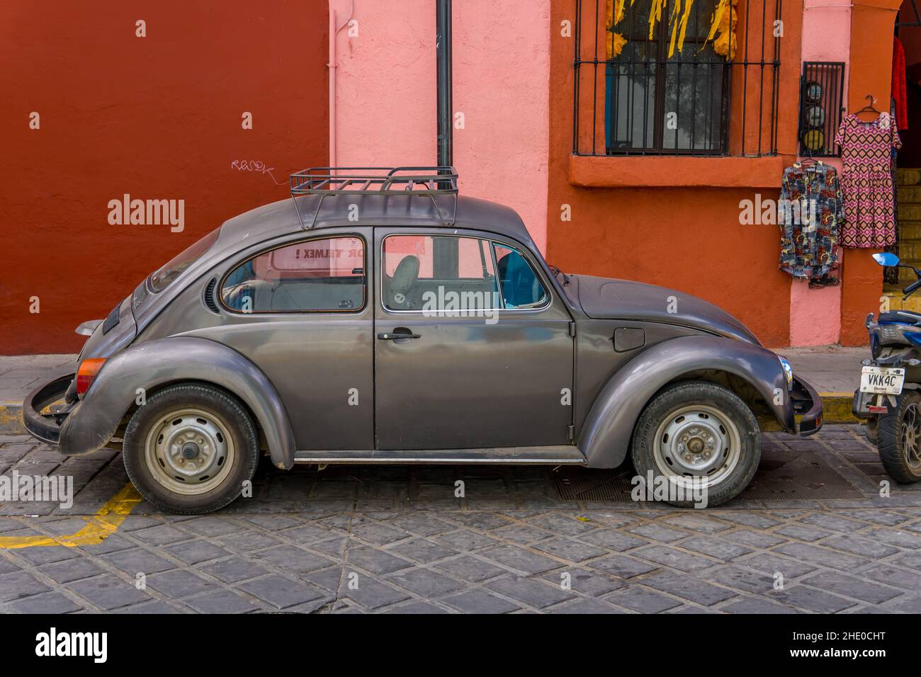 Closeup of a retro Classic grey VW Beetle in the streets in front of a ...