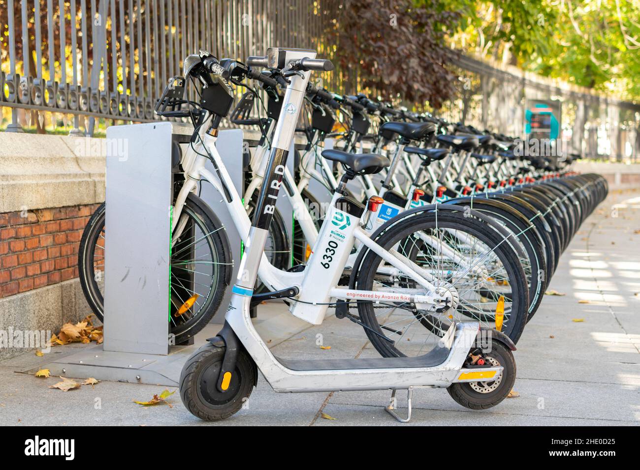 Bike share rental parking in Madrid with a scooter in front of it Stock ...