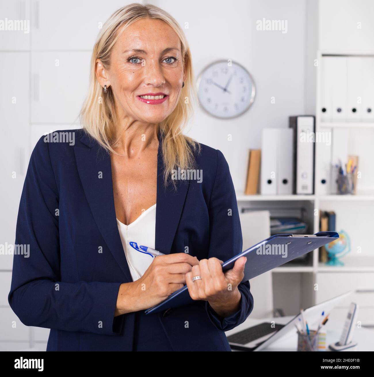 Mature woman writing down tasks Stock Photo - Alamy