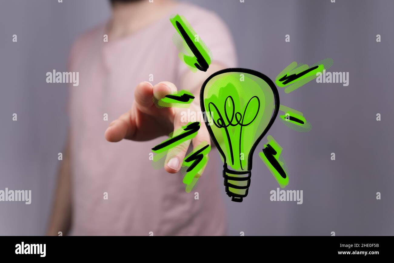 Hand pointing at a digital render of a green lightbulb - green ...