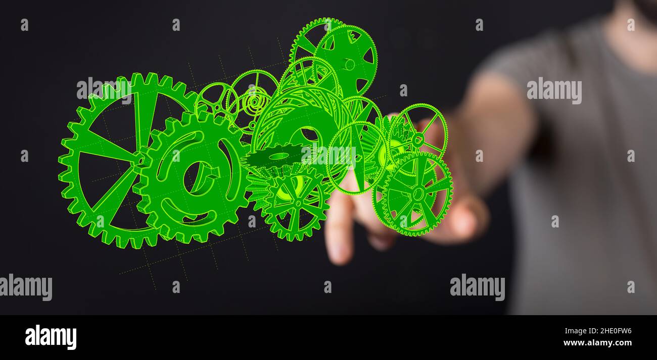 Closeup shot of a man showing the set of green gears and cogs on the ...