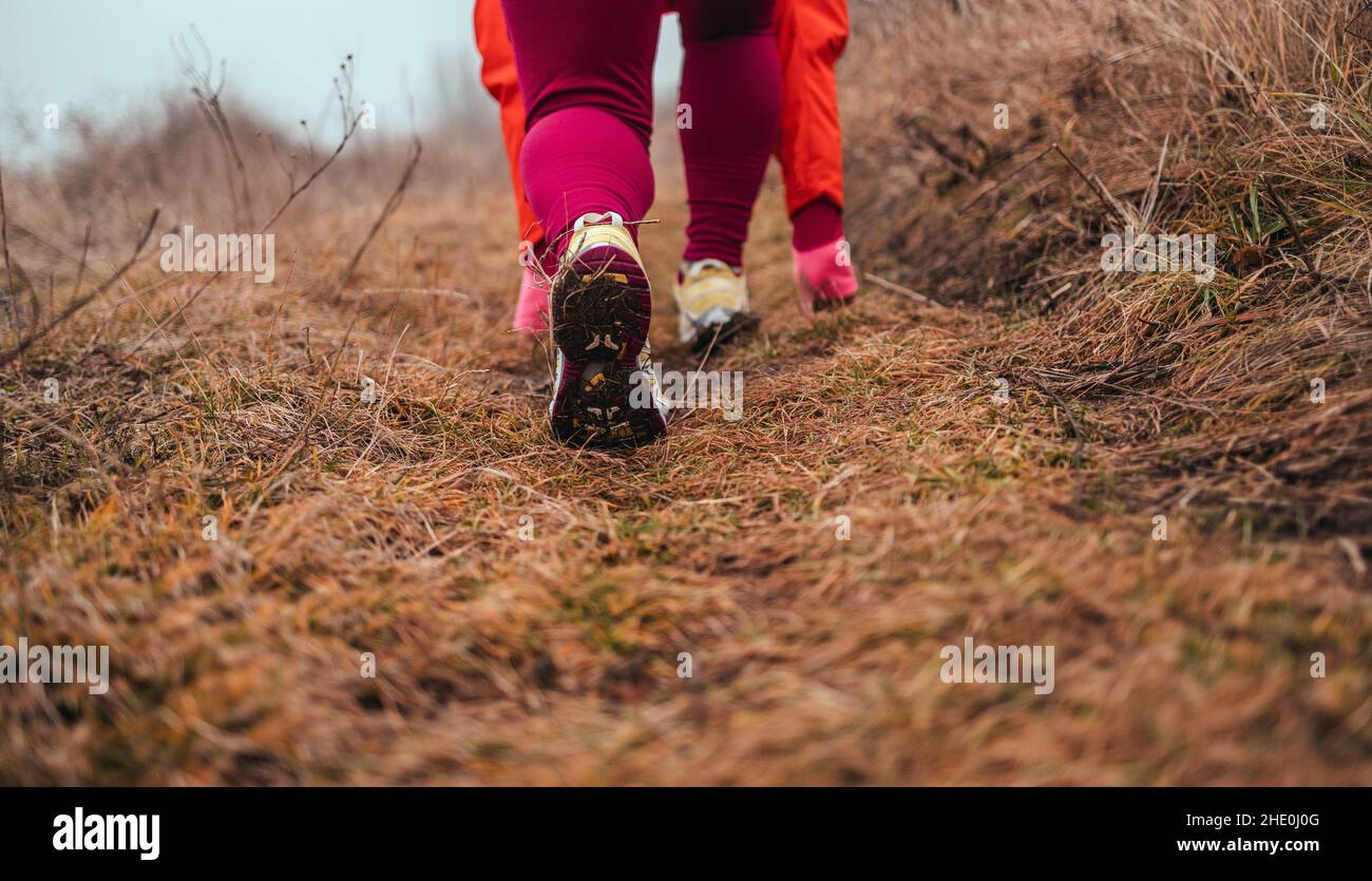 Closeup of female feet jogging in fitness training workout on off road ...