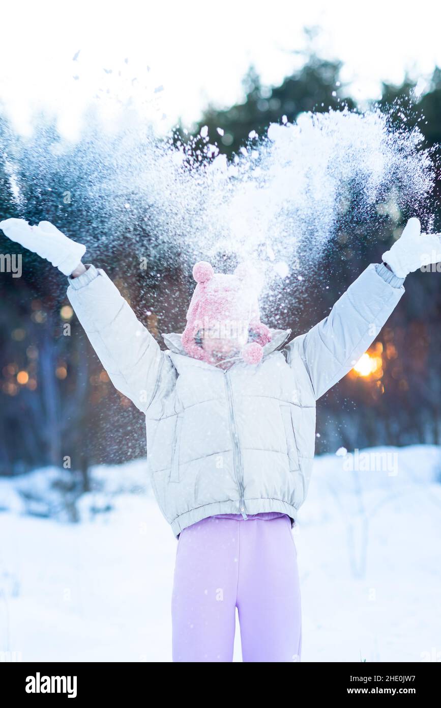 Cute little teenage girl having fun playing with snowballs, ready to ...