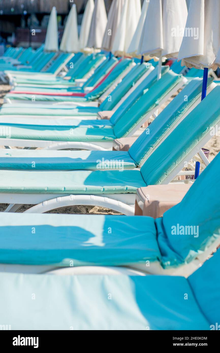 Empty blue sunbeds on a modern beach Stock Photo - Alamy