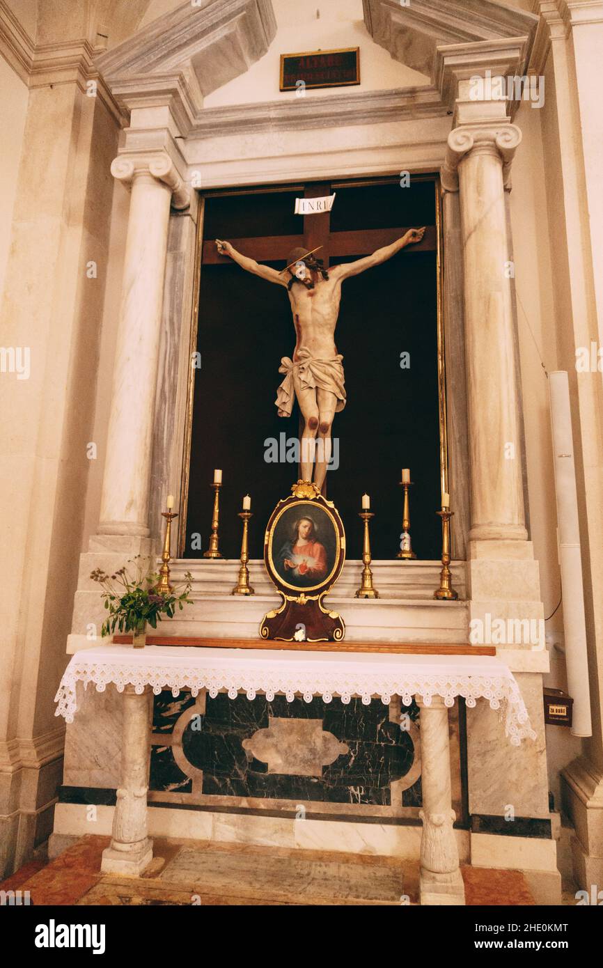 Statue of the Crucifixion on the wall of the temple between the columns ...