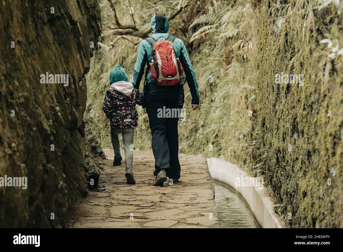 Mother and daughter walking along forest path Stock Photo - Alamy