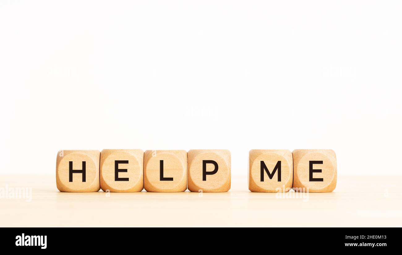 Help me concept. Phrase on wooden blocks on wood table. Copy space ...