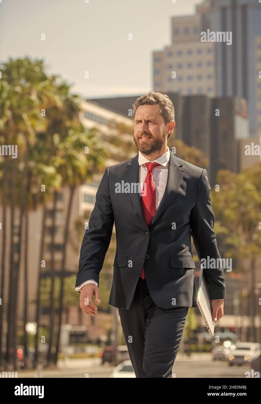 Professional man walking laptop computer hi-res stock photography and ...