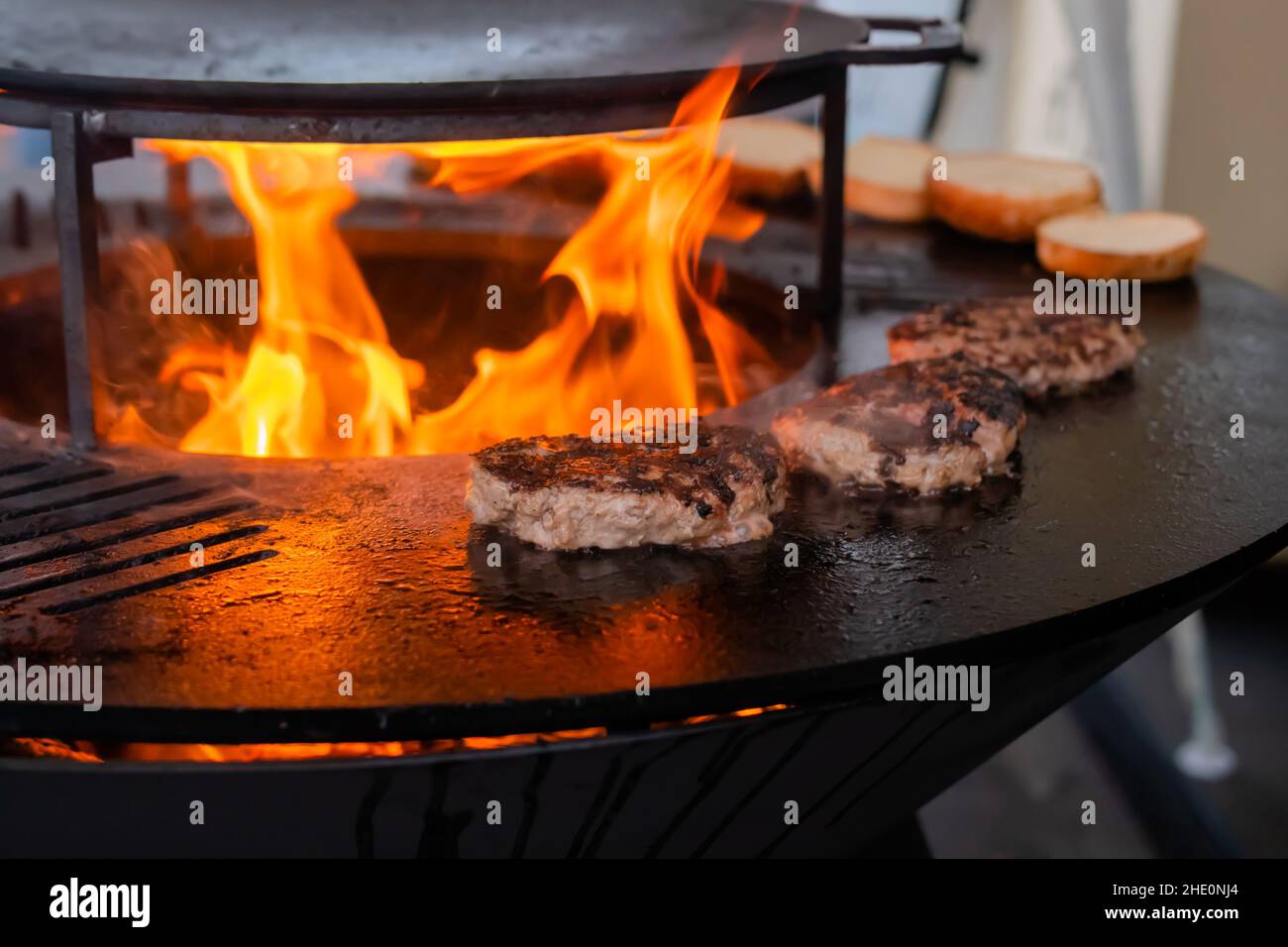 Process of grilling cutlets for burgers on brazier with hot flame Stock ...