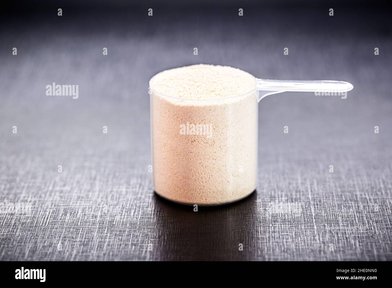 measuring spoon with casein and creatine, powdered food supplements ...