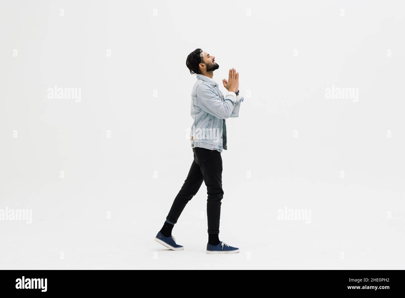 Young indian man look up and pray isolated over white background Stock ...